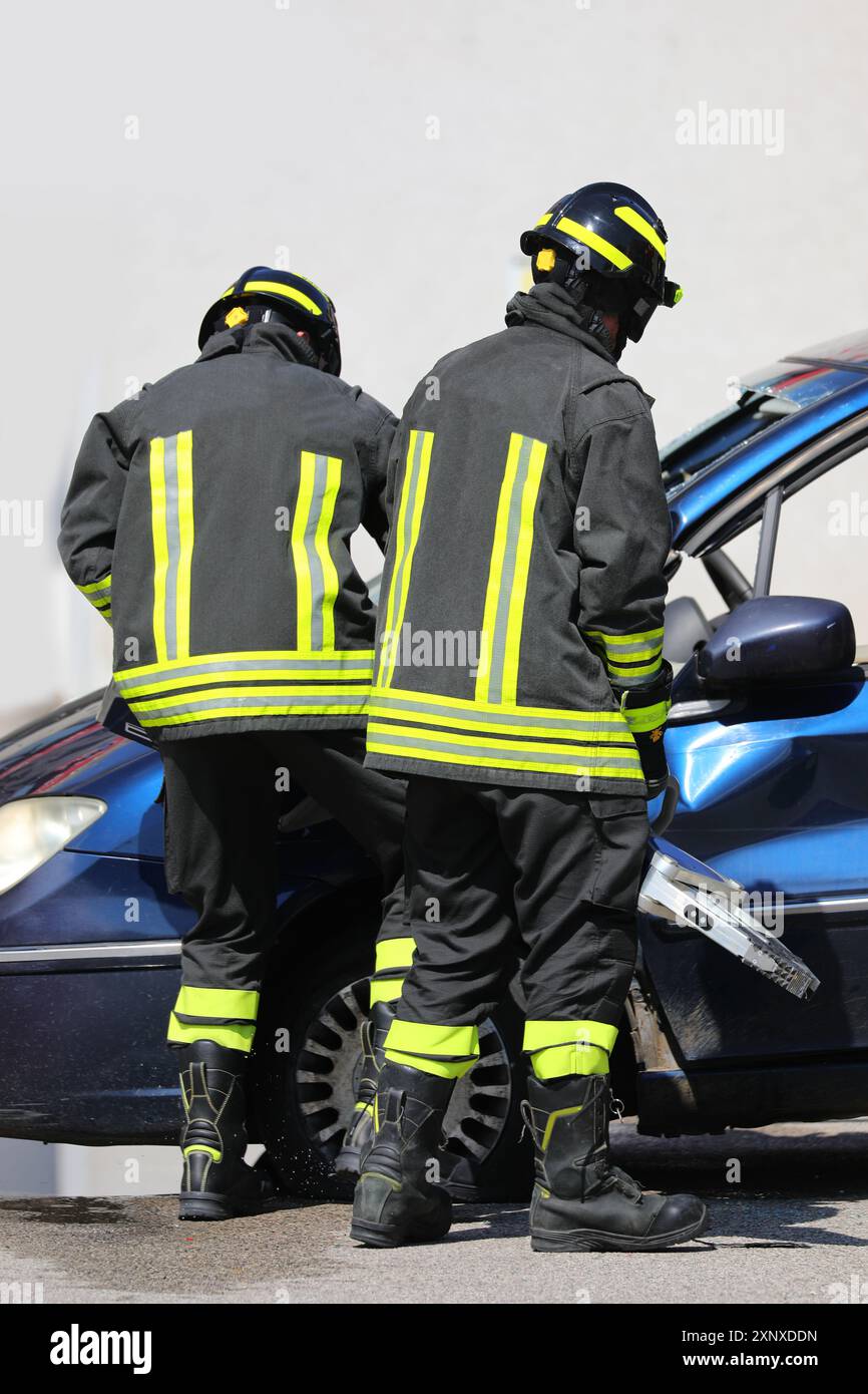 firefighters using powerful hydraulic shears and spreaders open the ...