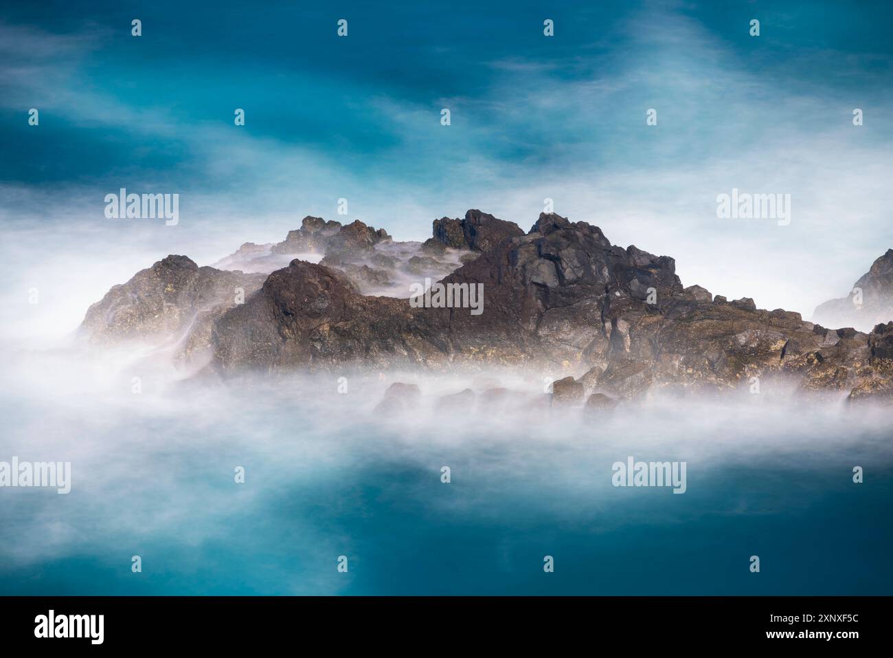 Aerial view of small rock island amongst waves, Madeira, Portugal ...