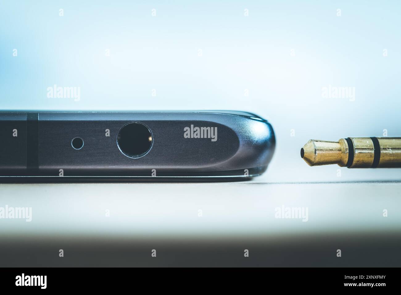 Connection 3.5mm audio jack to a black mobile phone Stock Photo - Alamy