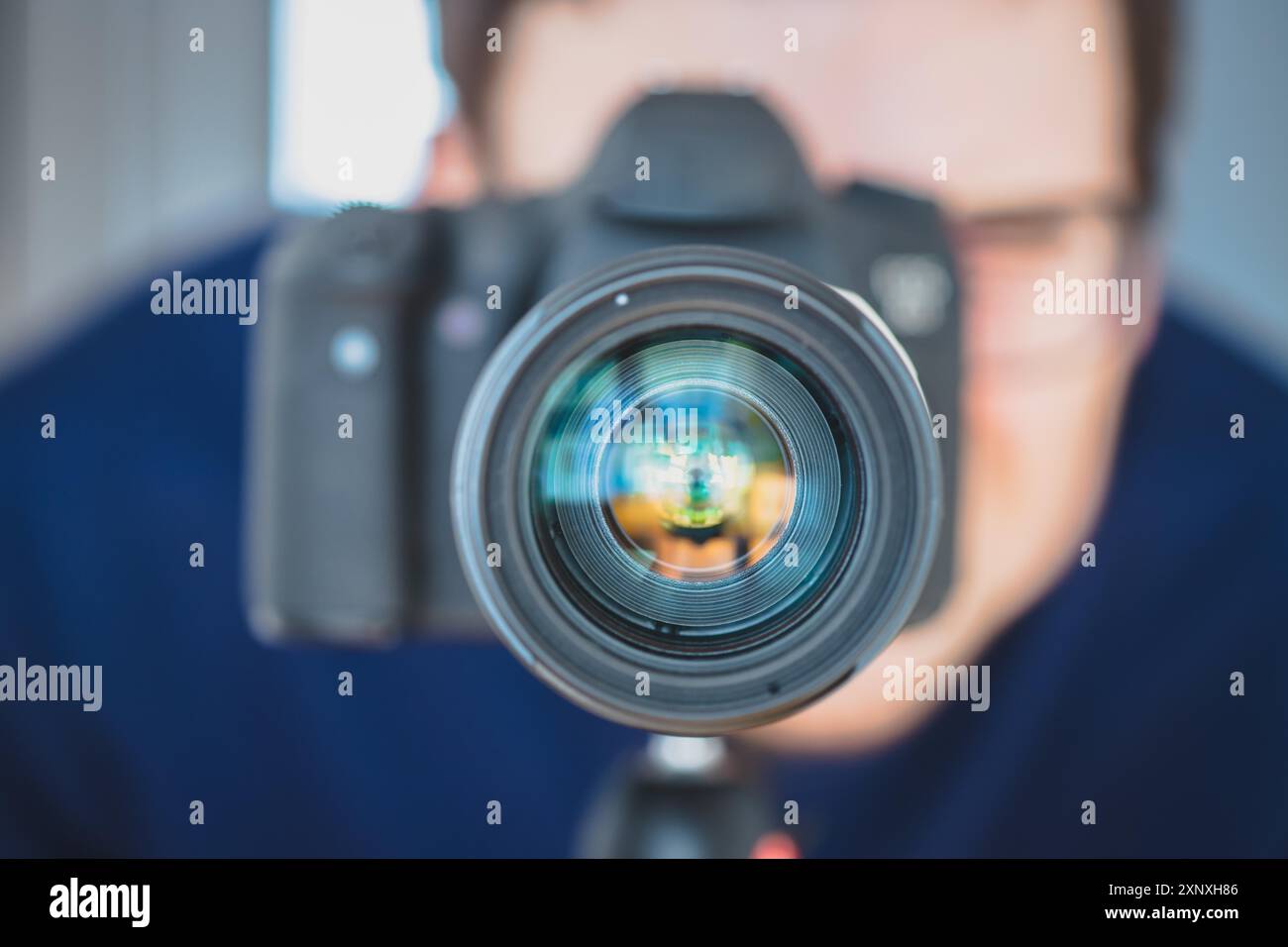 Photographer is standing behind a professional camera with telephoto ...