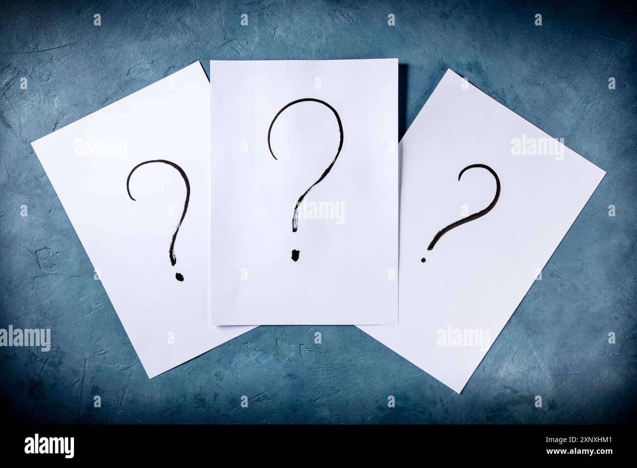 Question marks, written in ink on a piece of standard office paper ...