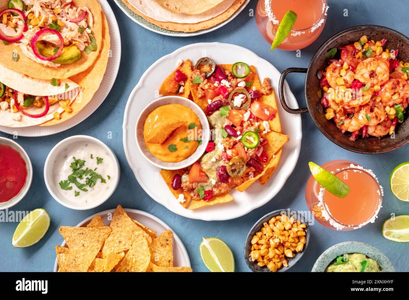 Mexican food, a flat lay. Nachos, tortillas, Paloma cocktails and other ...