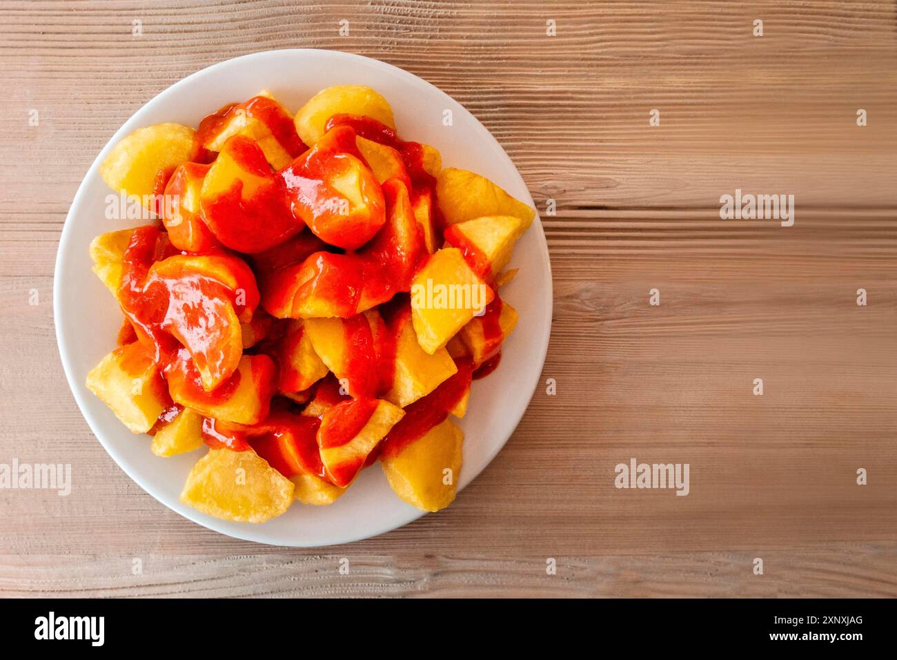 Patatas bravas, typical Spanish food. Potato with a spicy sauce, shot ...