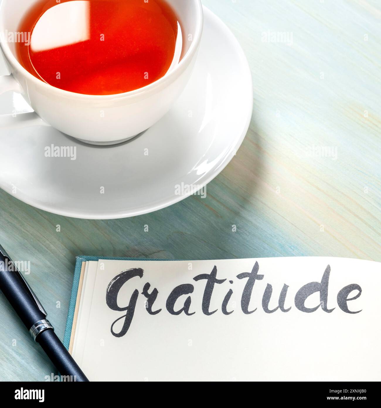 Gratitude journal with a pen and a cup of tea, square image Stock Photo ...