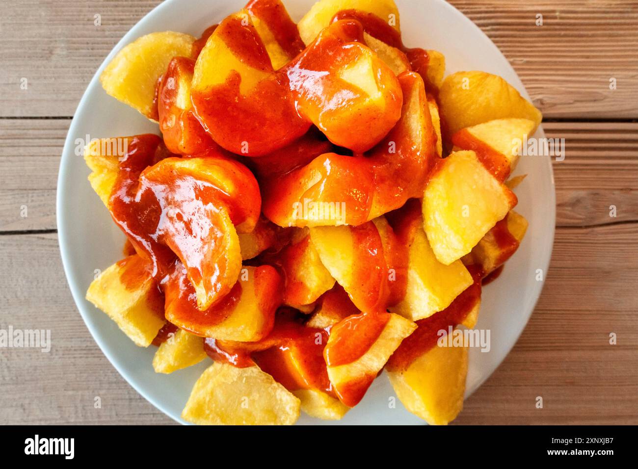 Patatas bravas, typical Spanish food. Potato with a spicy sauce ...