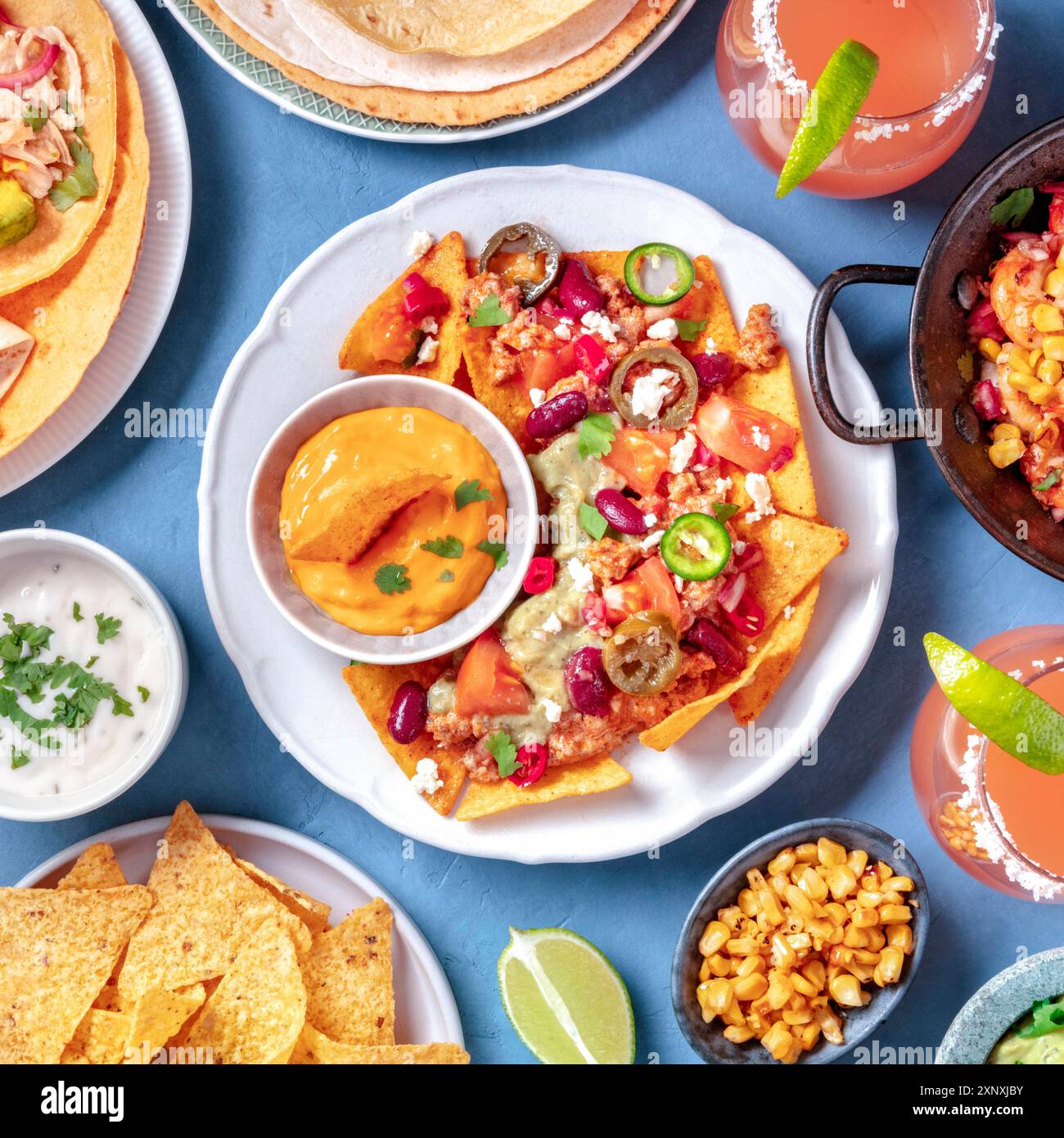 Mexican food, a flat lay. Nachos, tortillas, Paloma cocktails and other ...
