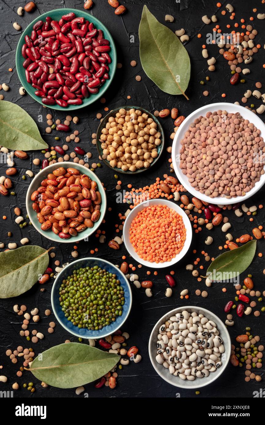 Various legumes, shot from the top on a dark background. Lentils ...