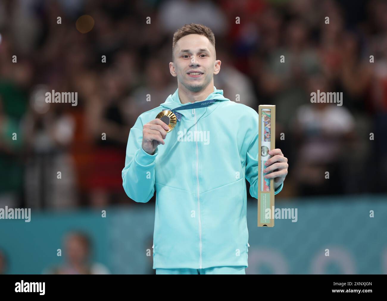 AIN's Ivan Litvinovich celebrates with his gold medal after the ...