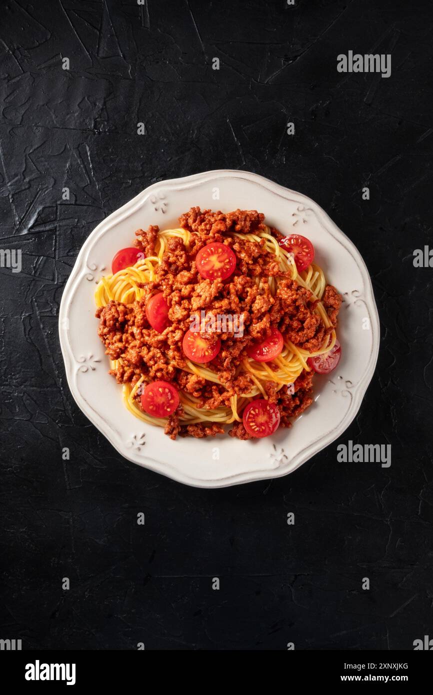 Spaghetti bolognese pasta, top shot on a dark background with a place ...
