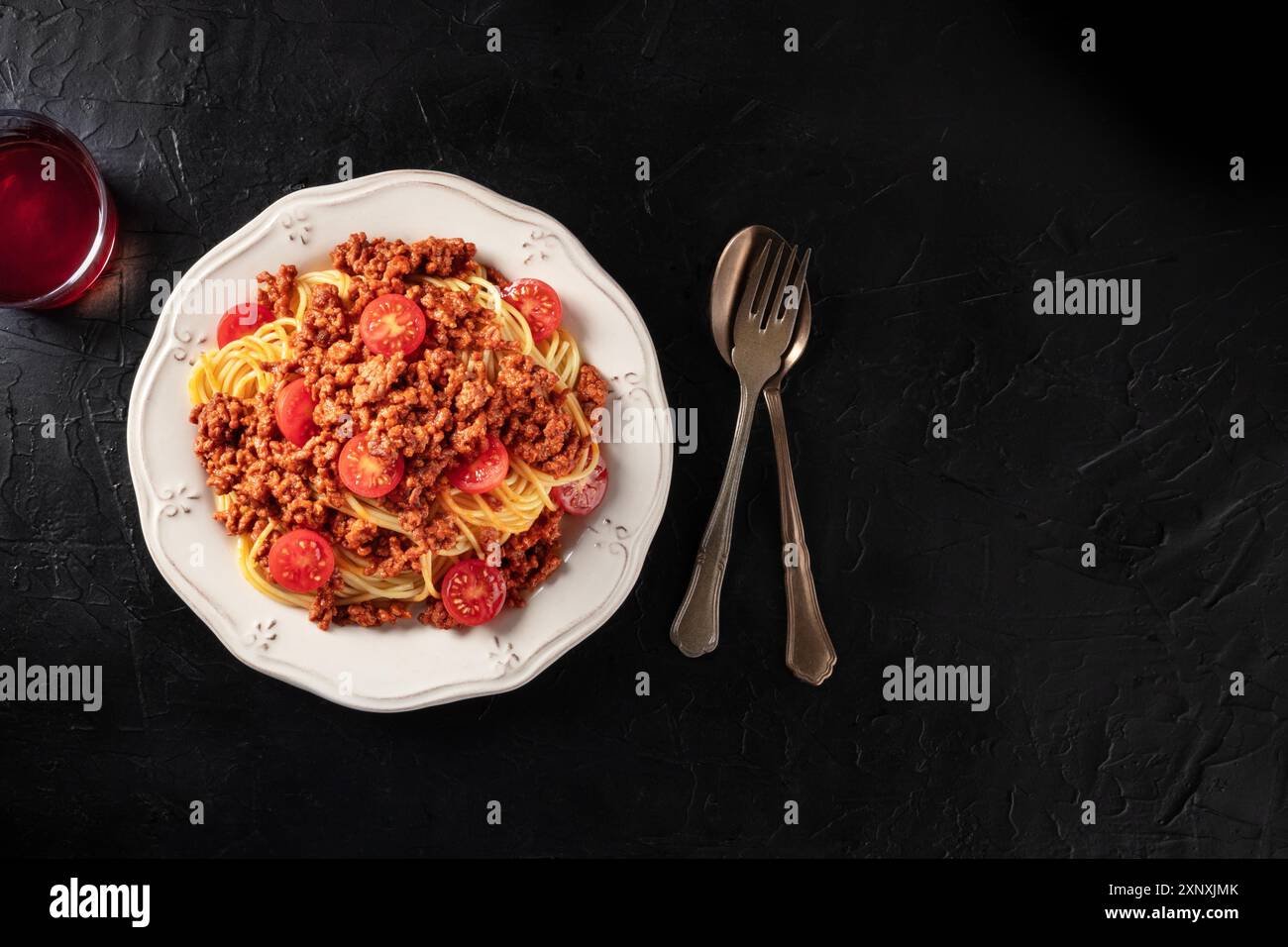 Spaghetti bolognese pasta, shot from above on a black background with a ...