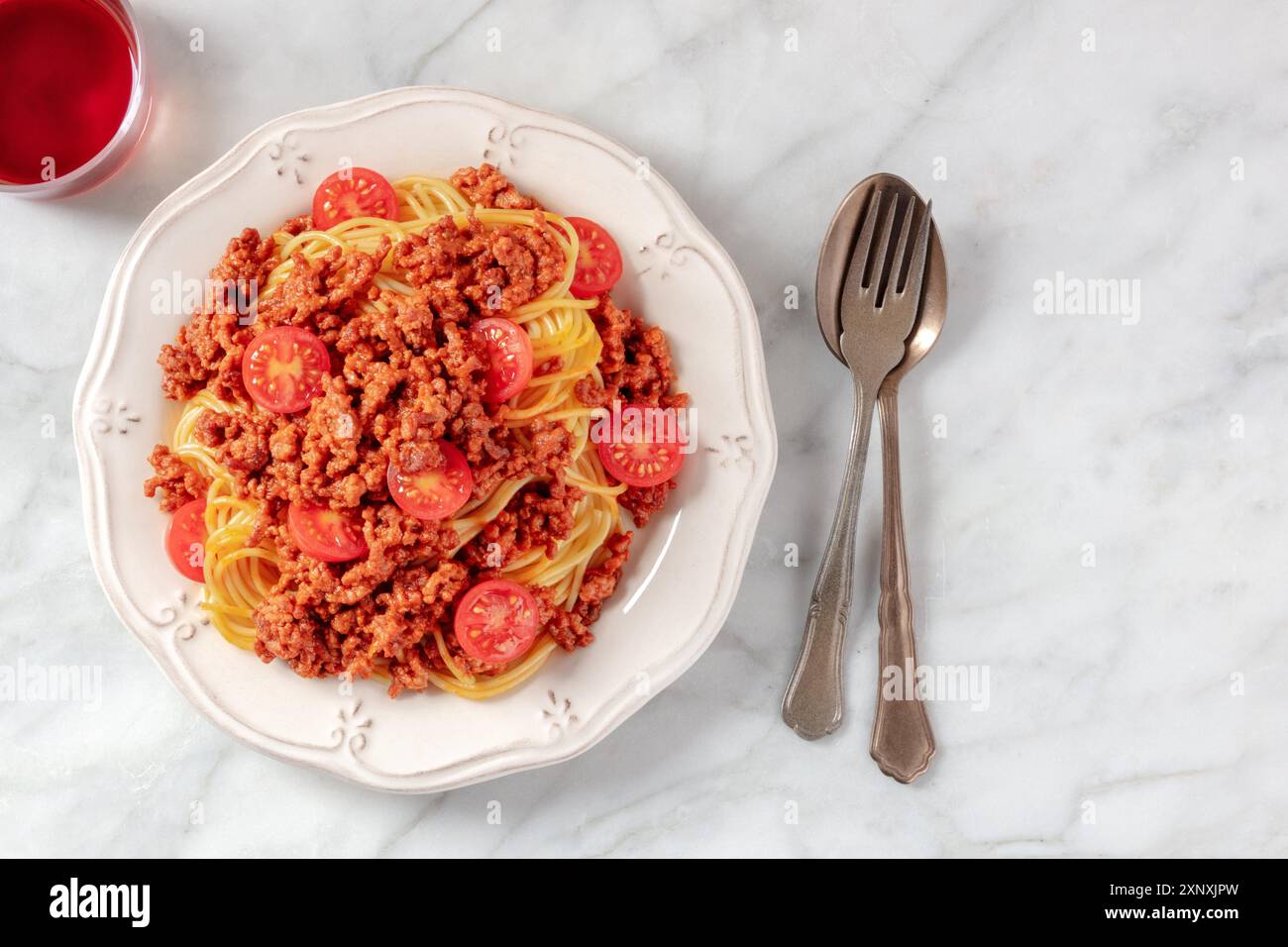 Spaghetti bolognese, shot from the top on a white marble background ...