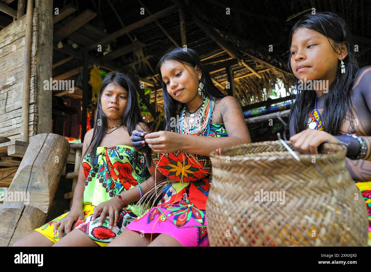 Esilda and her friends making basket, young teenagers of Embera native ...