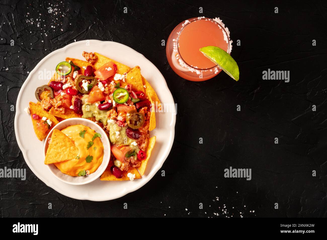 Mexican nachos with chili con carne and a Paloma cocktail, top shot on ...