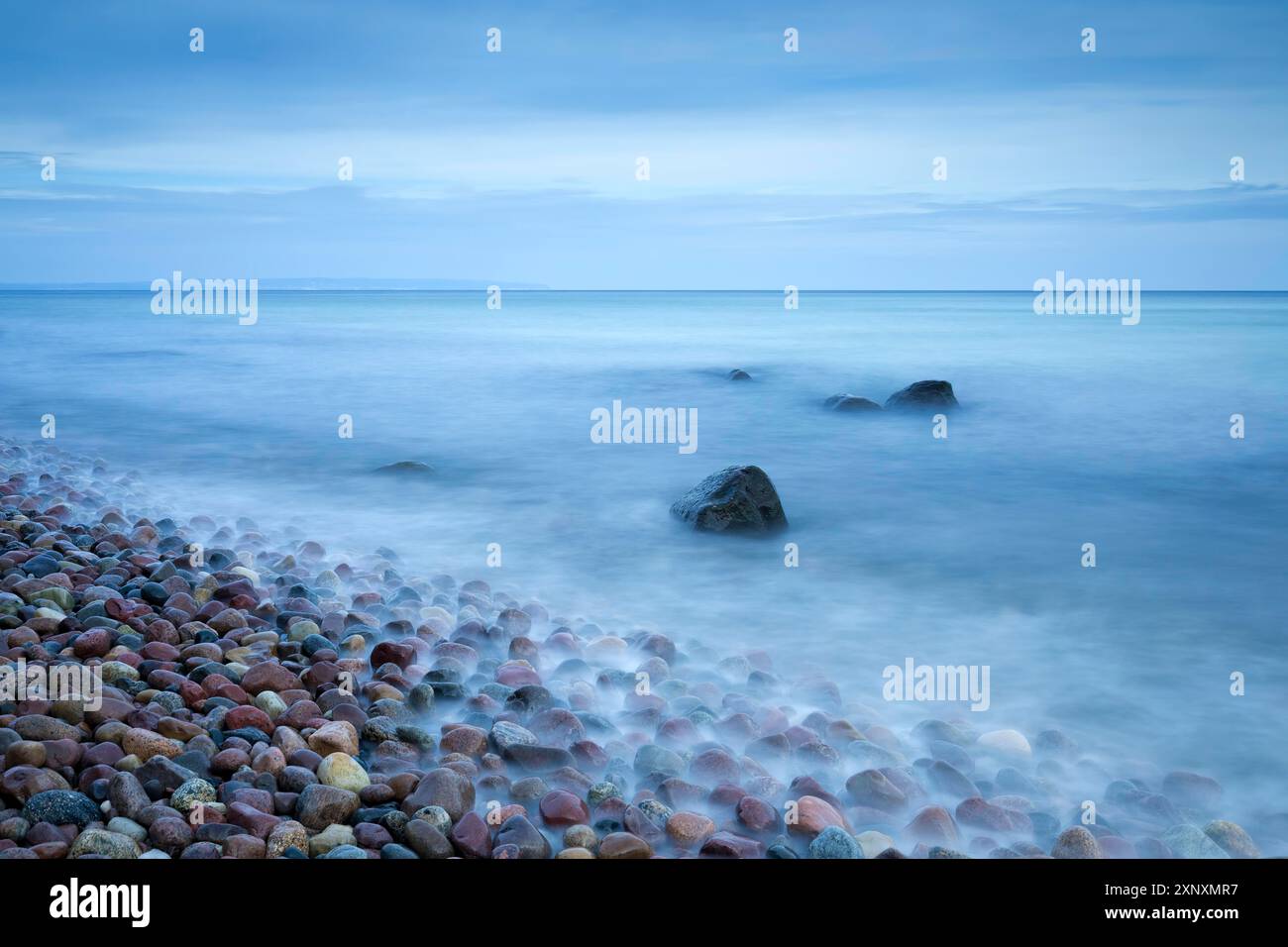 Pebbles and sea with long exposure Stock Photo - Alamy