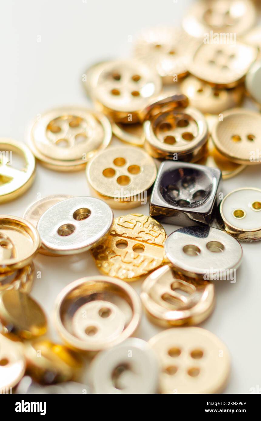 A pile of buttons of various shapes and sizes. The buttons are ...
