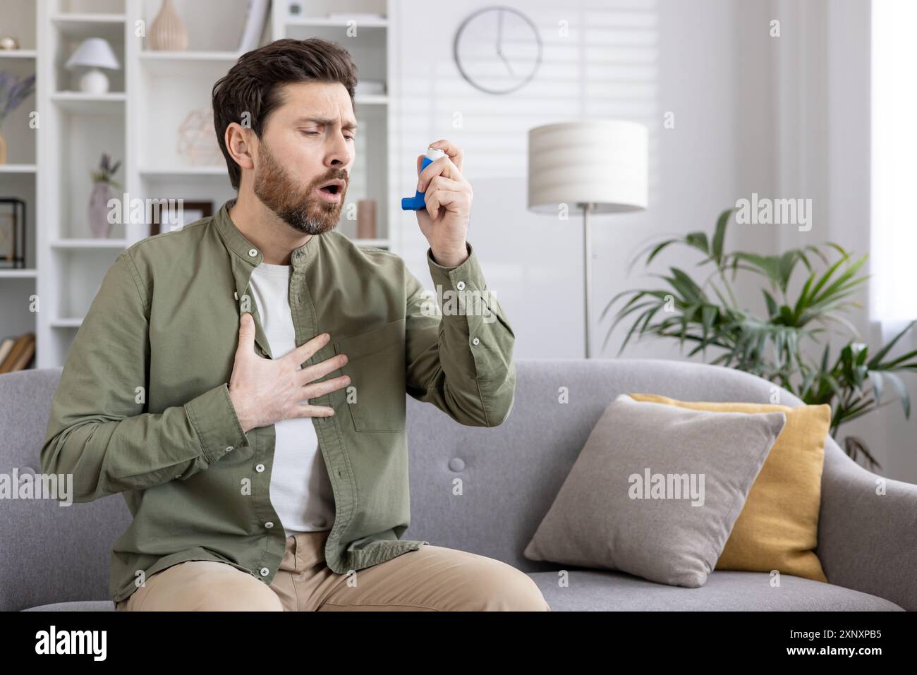 Man experiencing breathing difficulty while using asthma inhaler ...