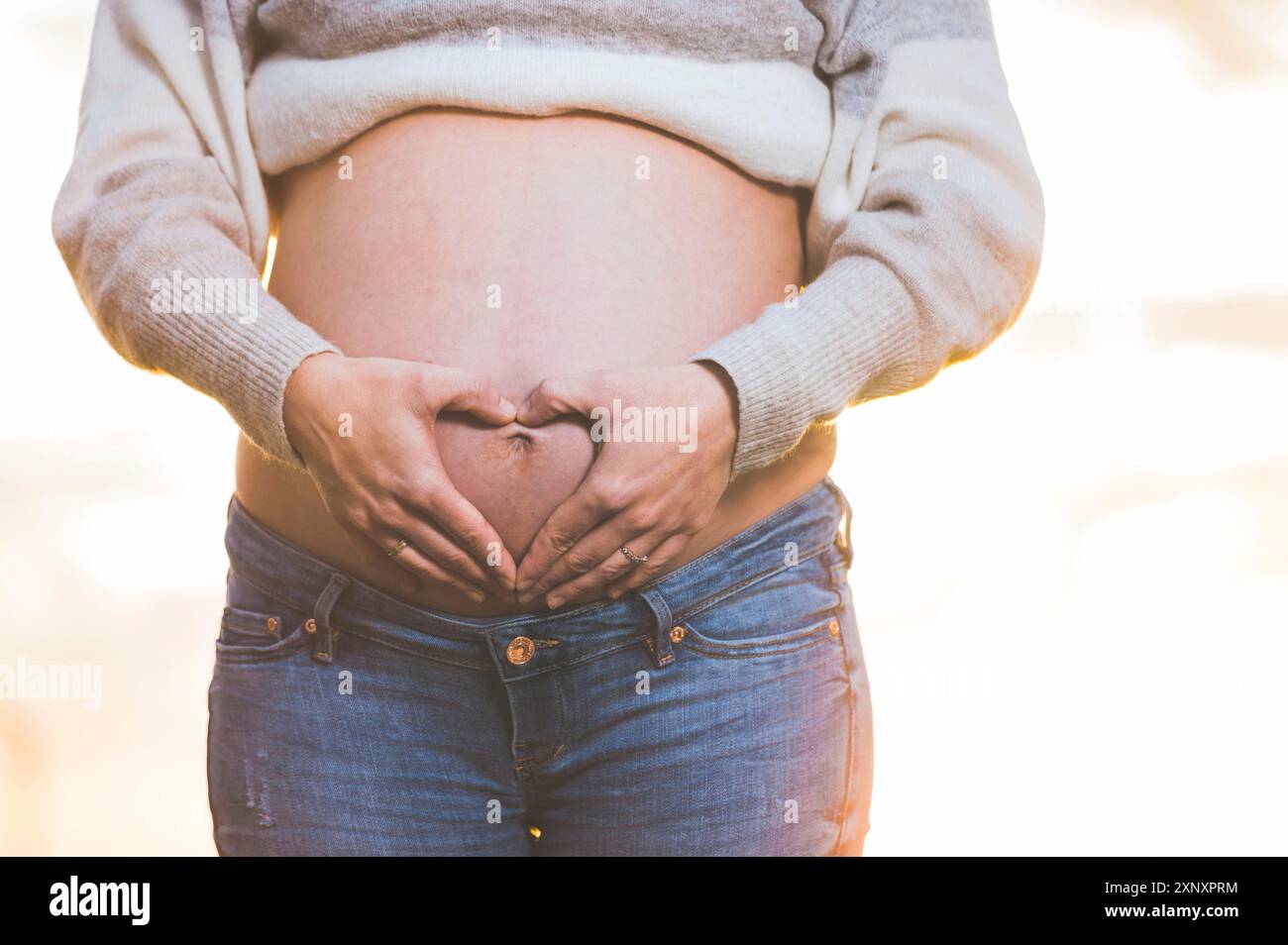 Womans hands on pregnant belly hi-res stock photography and images - Alamy