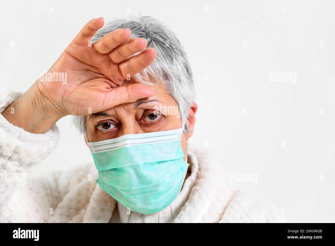 Covid-19. Sick senior woman portrait, wearing face protection mask ...