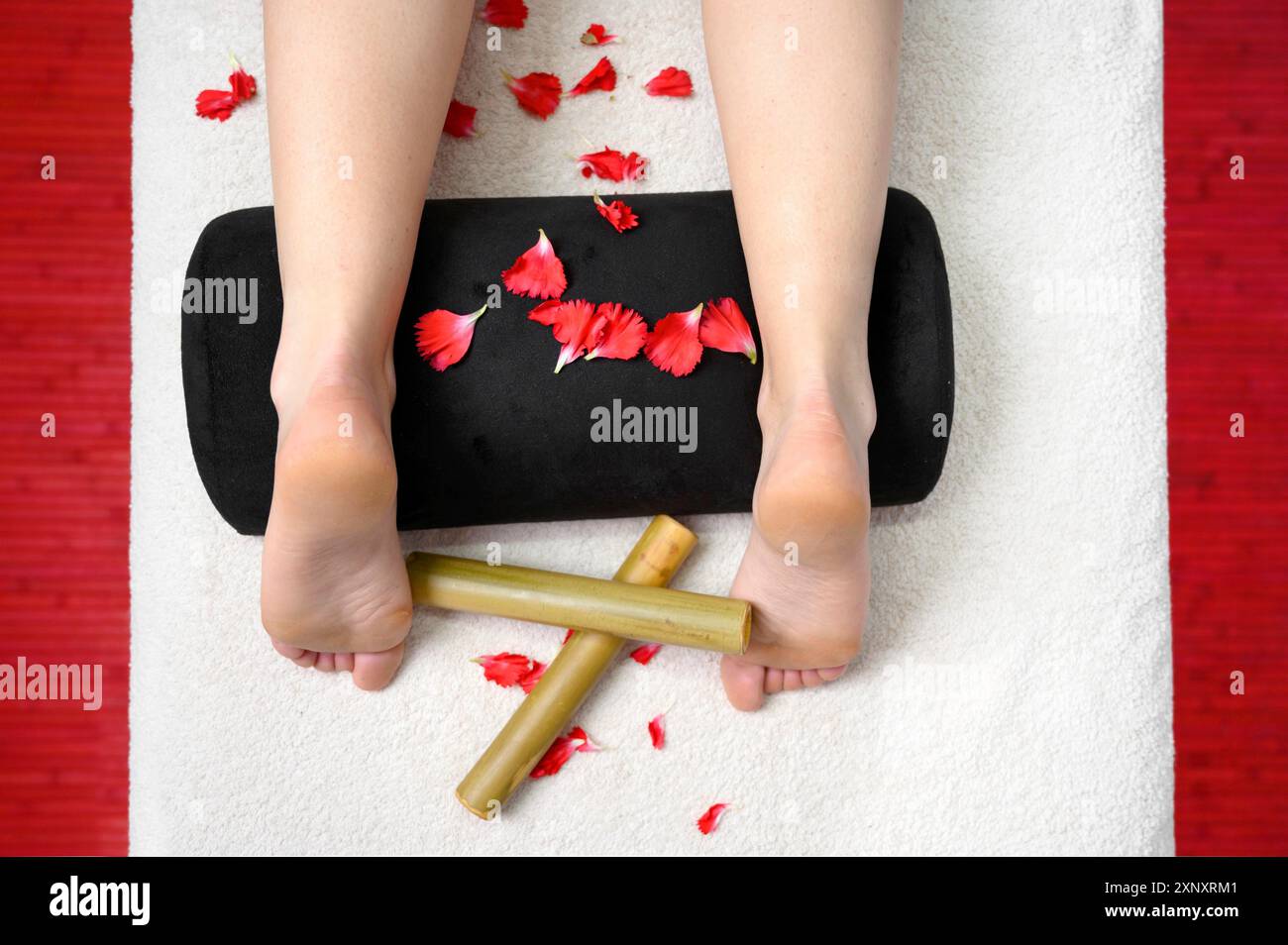 Female feet, bamboo sticks and flower petals. Thai massage, Spa and ...