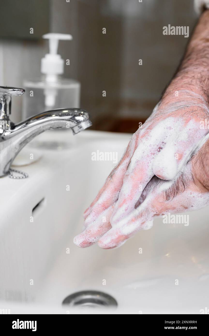 Close up of Senior man washing his hands using soap foam, Prevention ...