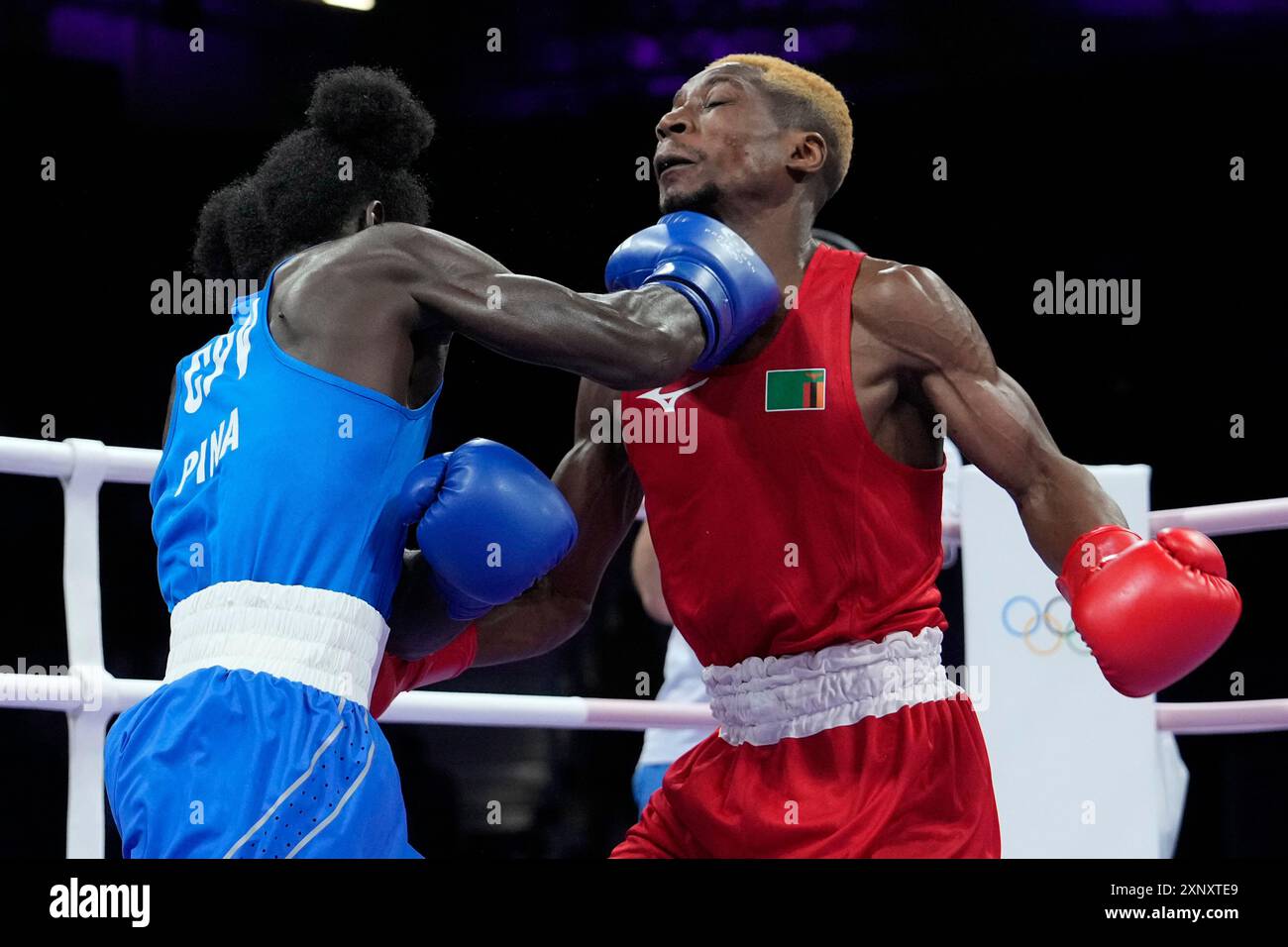 Cabo Verde's David De Pina hits Zambia's Patrick Chinyemba in their men's 51 kg quarterfinal ...