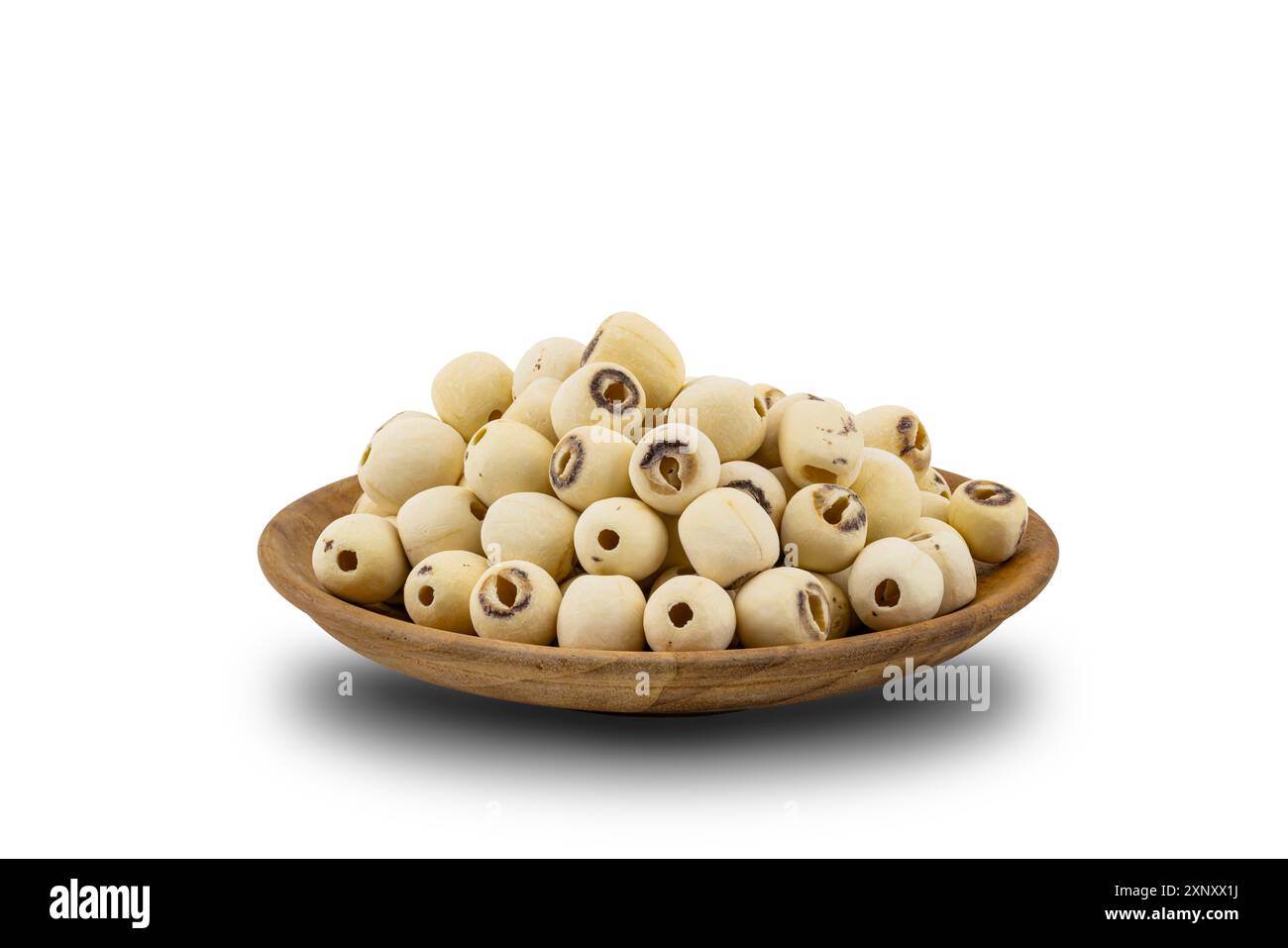 Pile of Dried Lotus Seeds in a wooden plate on white background with ...