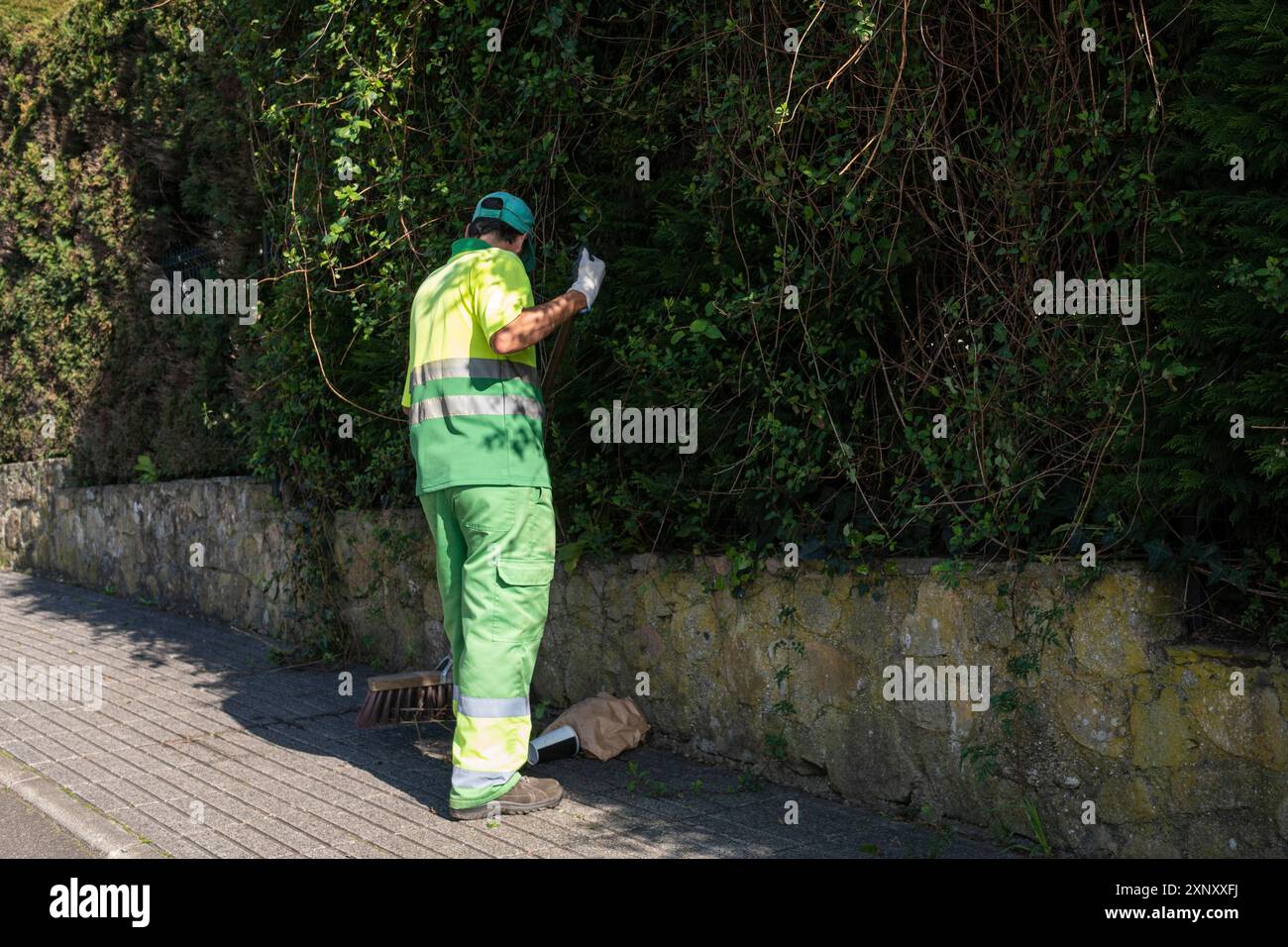 Street sweeper with broom working on a sidewalk. Public cleaning ...