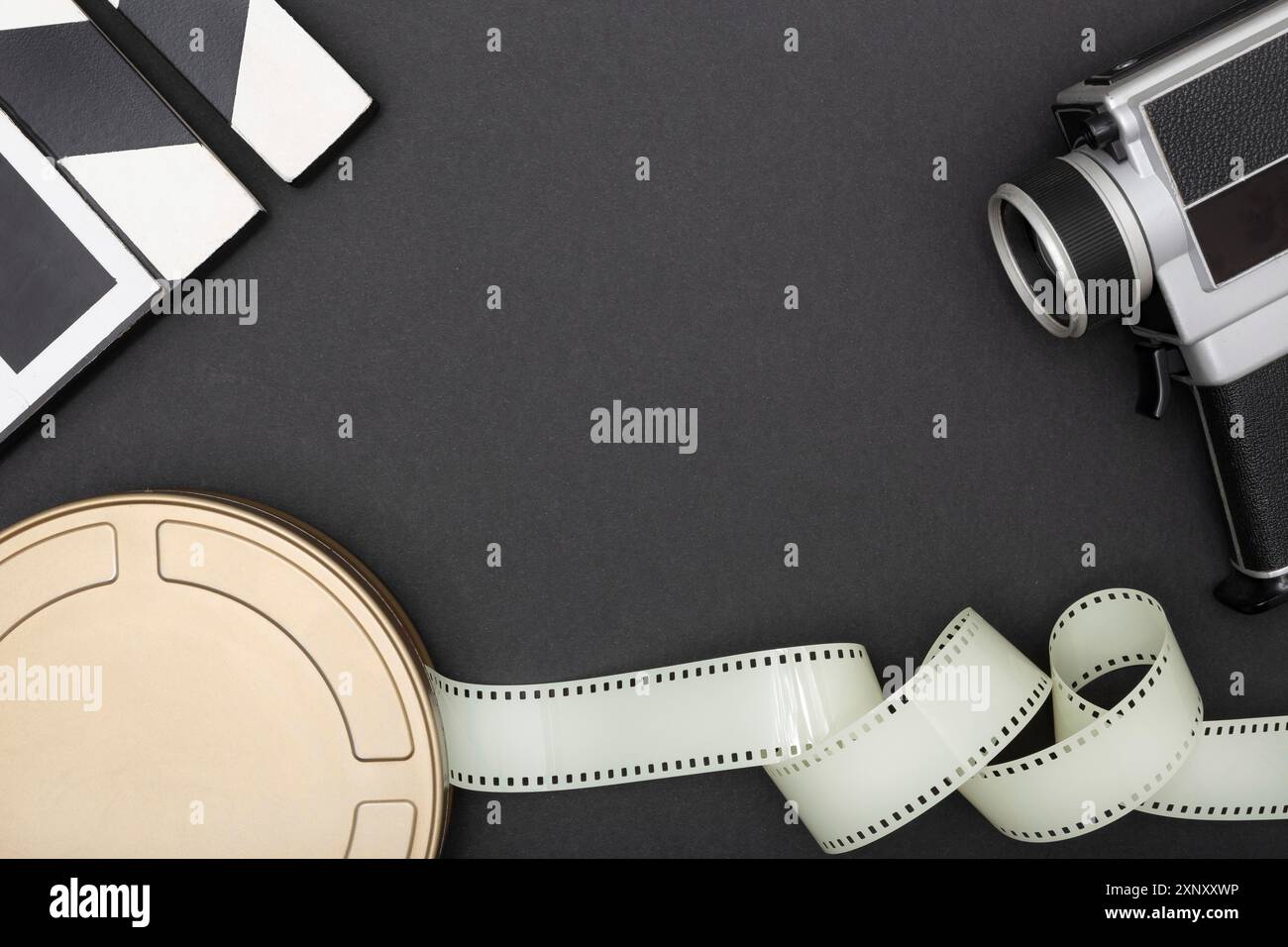 Motion Picture Film Can, film camera and film strip on black background ...