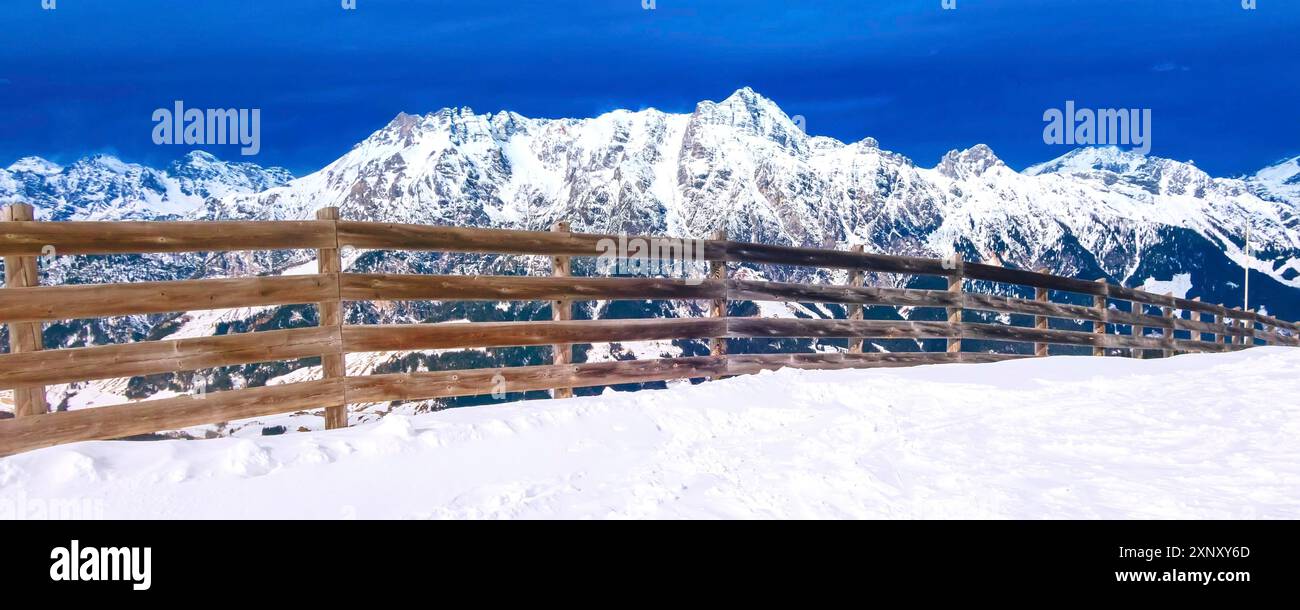 Panorama banner of snow mountain peaks landscape with wooden fence ...