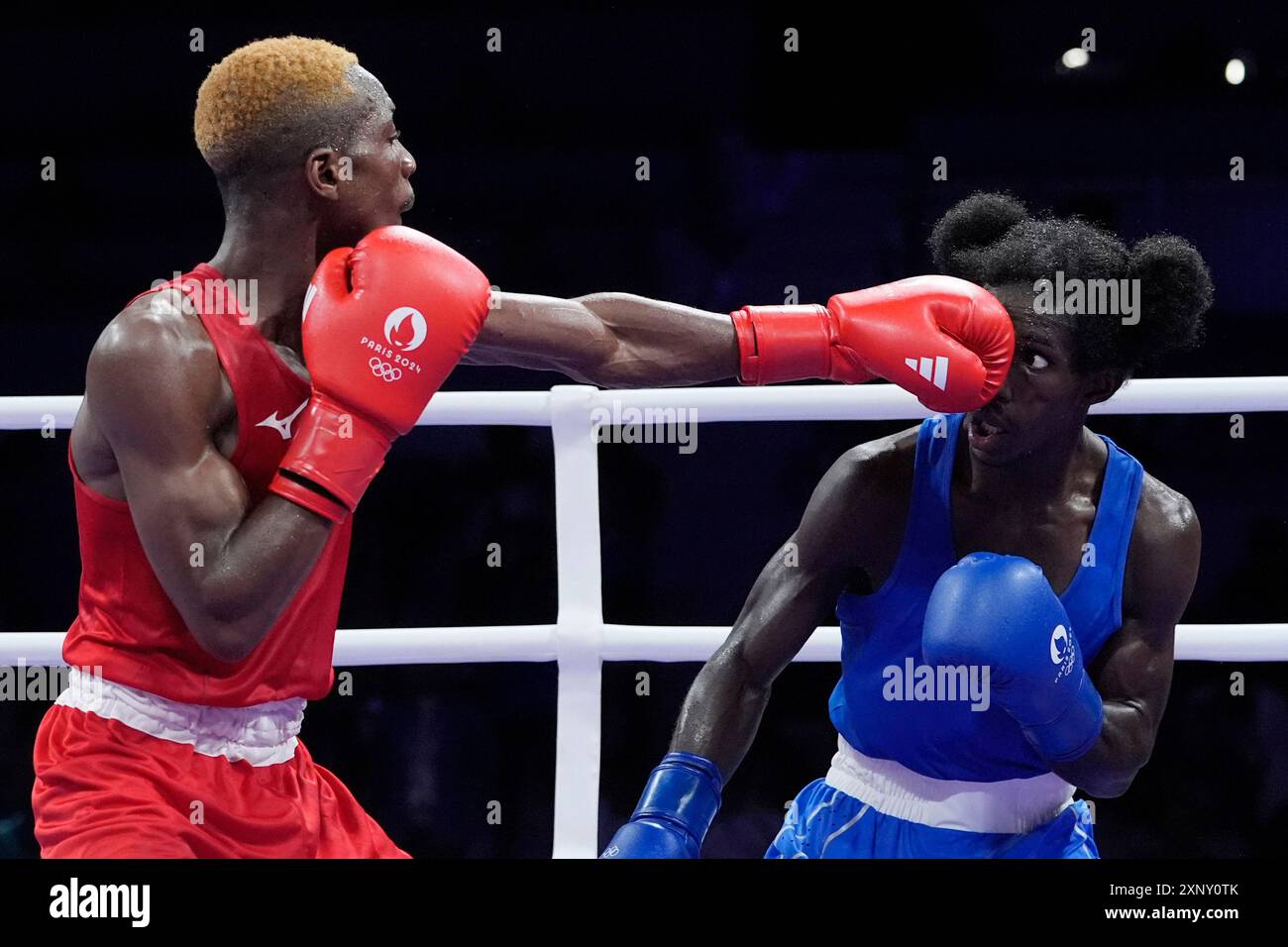 Zambia's Patrick Chinyemba hits Cabo Verde's David De Pina in their men's 51 kg quarterfinal ...