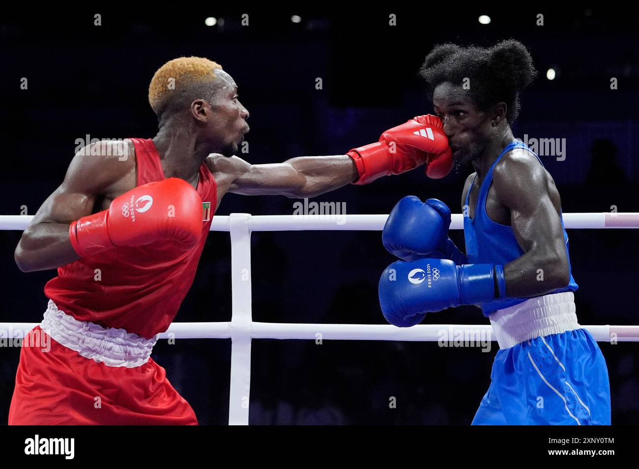 Zambia's Patrick Chinyemba hits Cabo Verde's David De Pina in their men's 51 kg quarterfinal ...