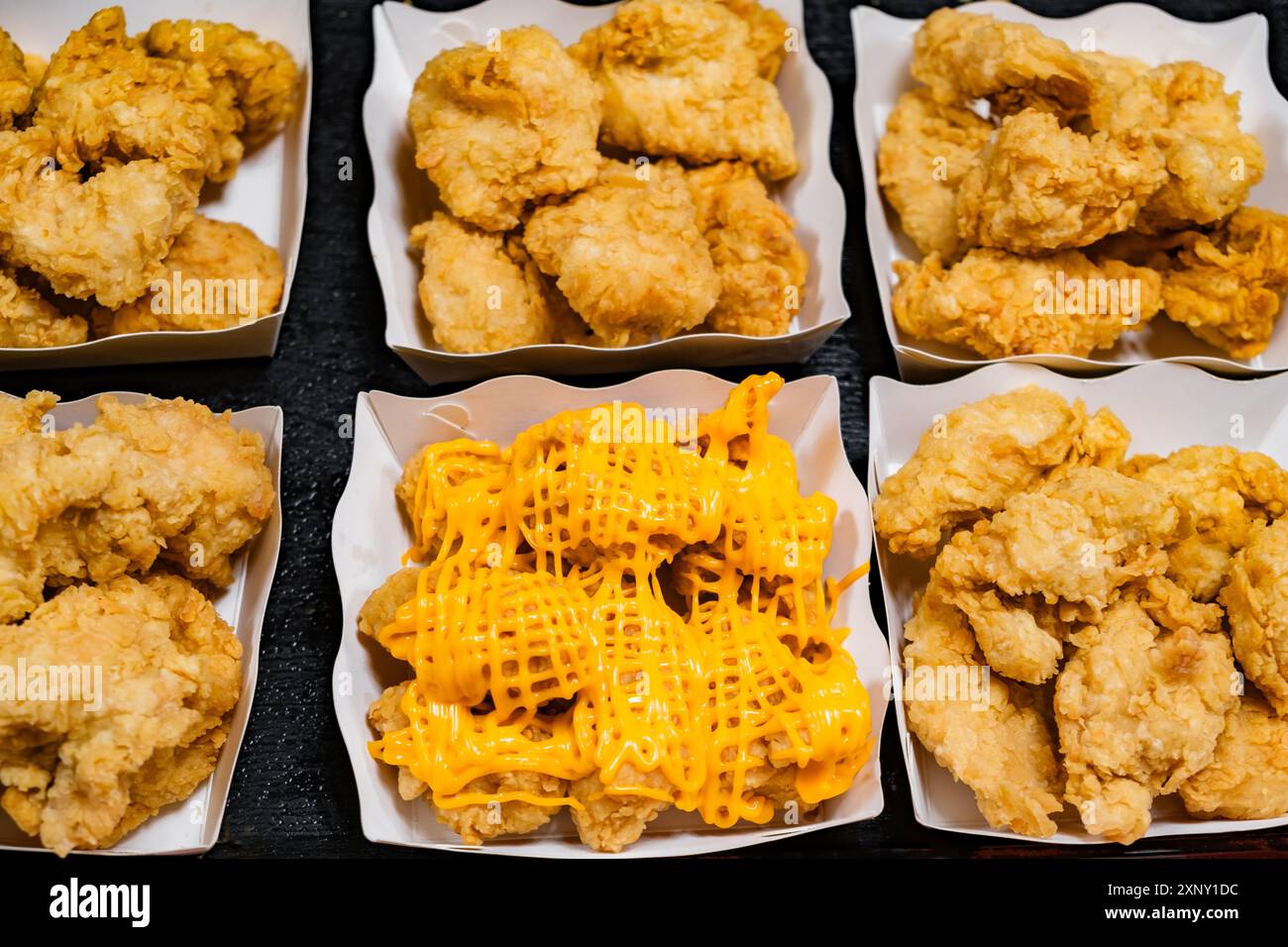 chicken nuggets cooked in paper containers, on street food market Stock ...