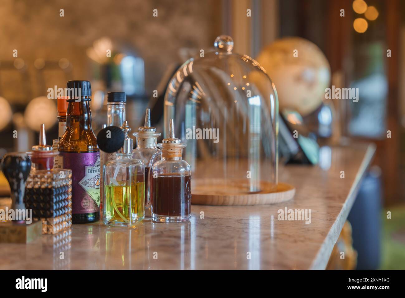 A sophisticated bar counter featuring a marble top, various bottles of ...