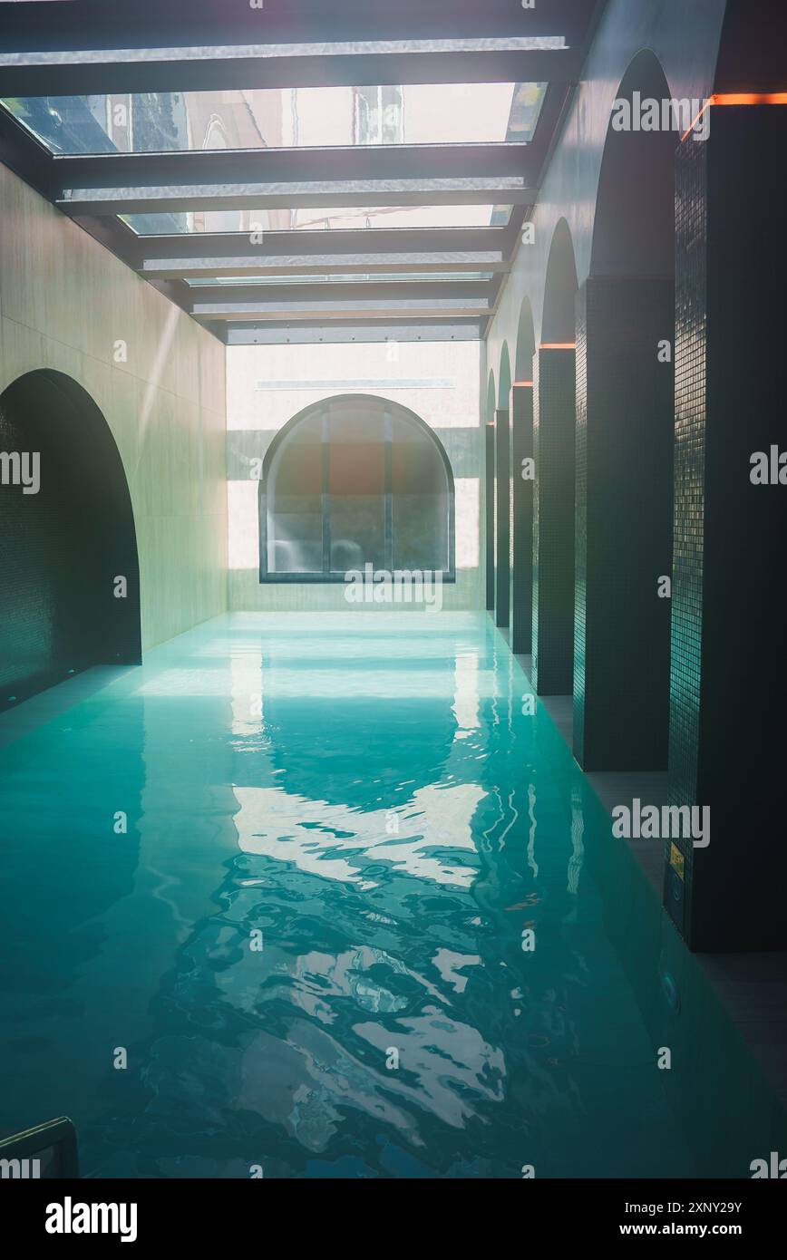 Elegant indoor swimming pool in a high-end luxury hotel, featuring ...
