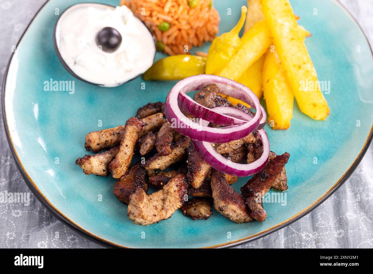Greek gyros on a plate with chips Stock Photo - Alamy