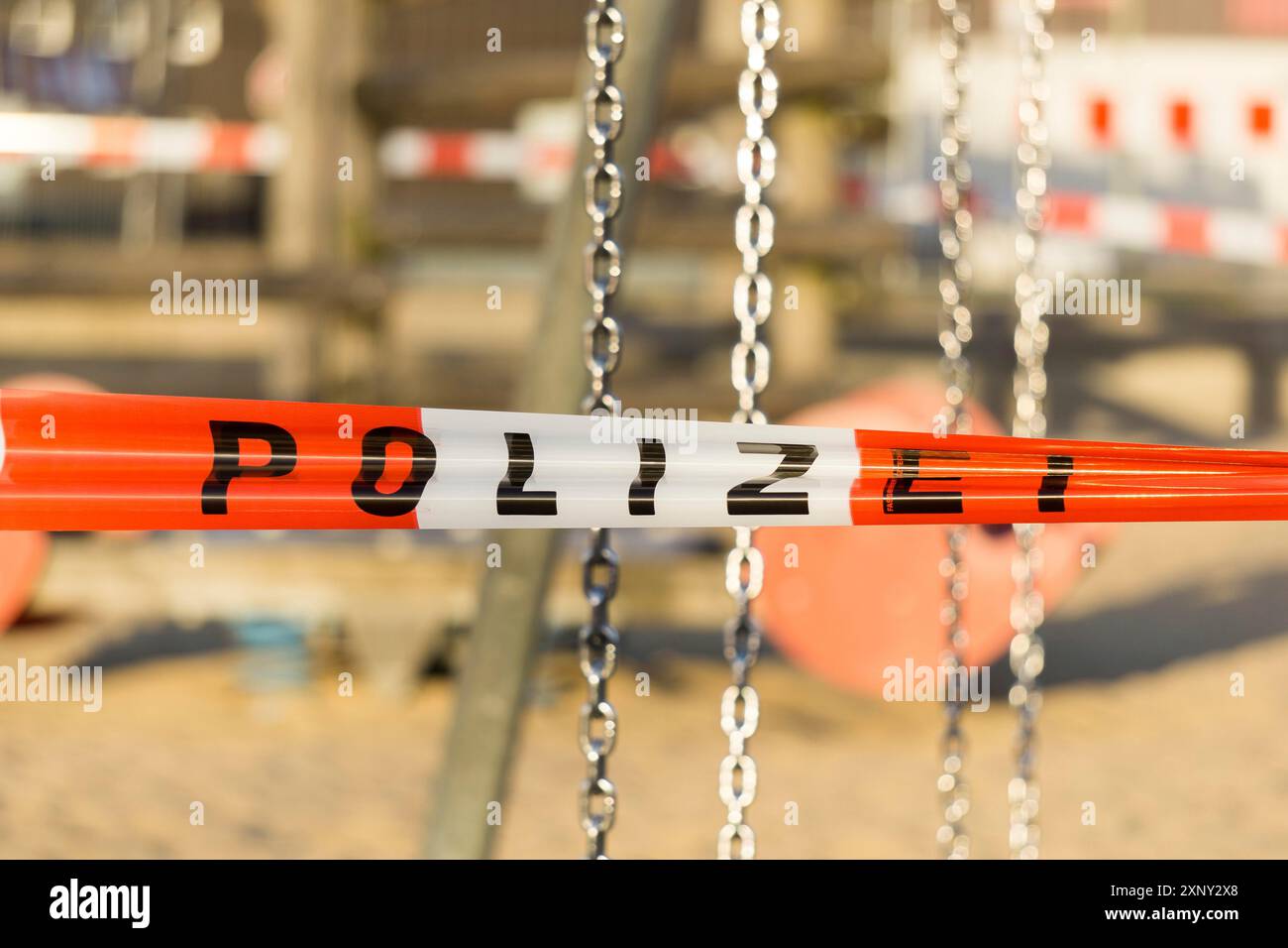 Children's playground closed off by police barrier tape Stock Photo - Alamy