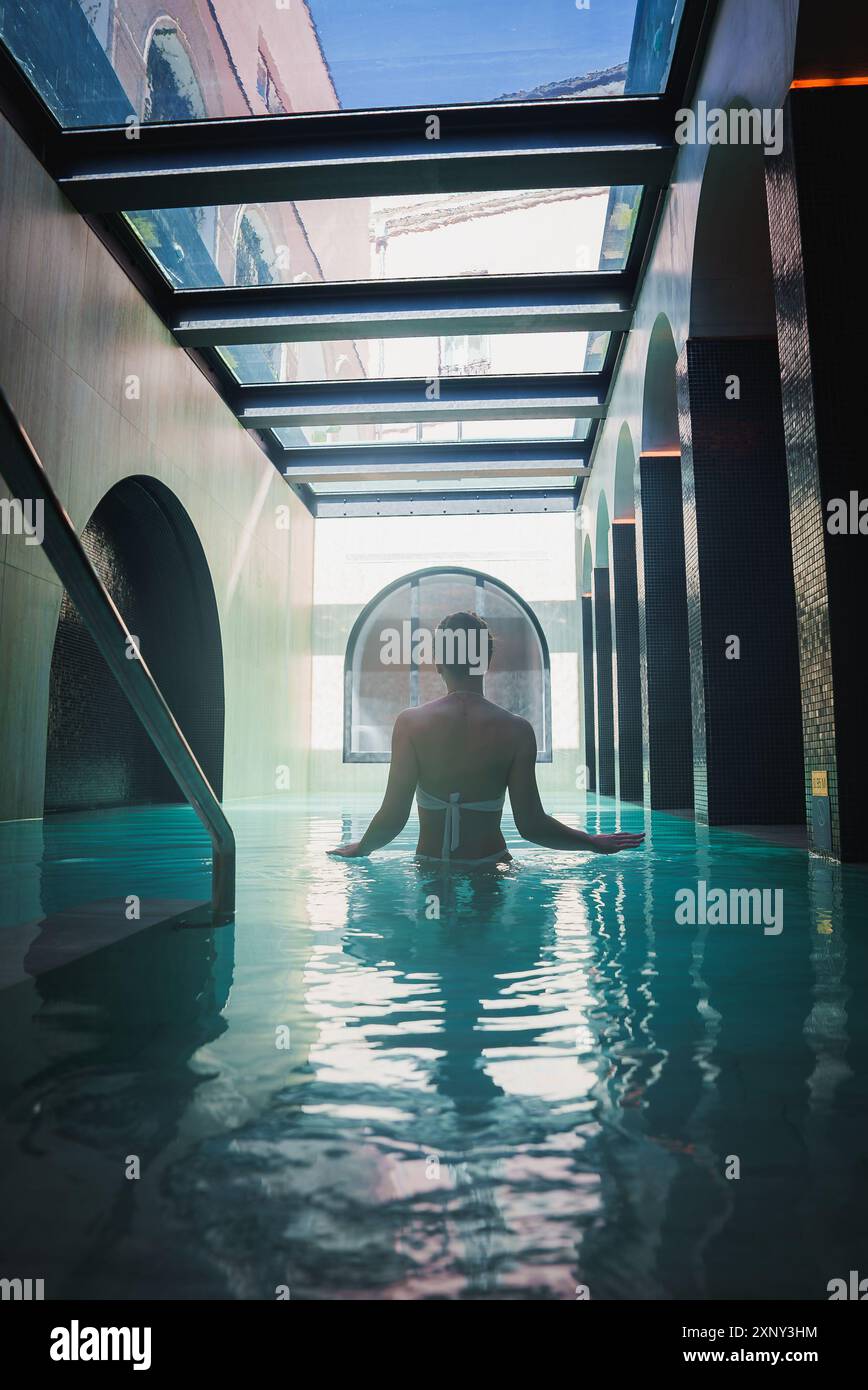 Serene Indoor Pool with Arched Doorways and Glass Ceiling in Luxury ...