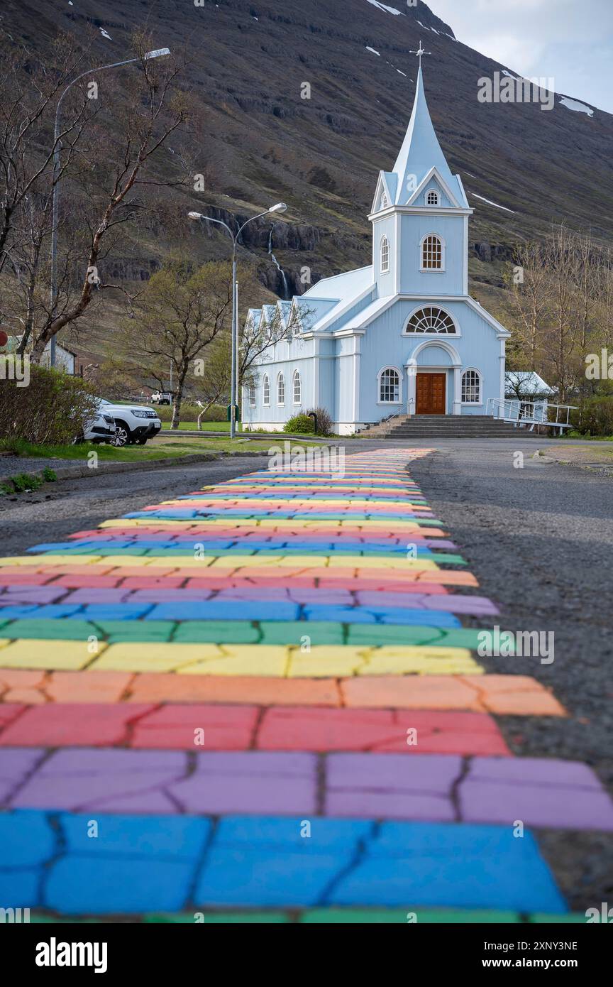 Church with Rainbow Road at Seydisfjordur, Iceland, view from low angle ...