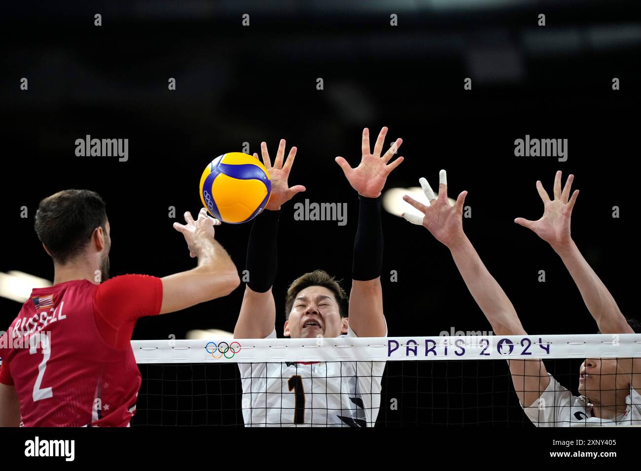 Yuji Nishida, of Japan, tries to block an ball by Aaron Russell, of the ...