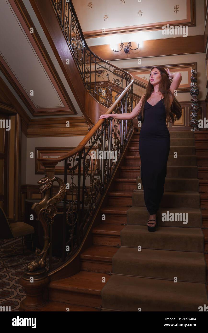 Elegant Woman Descending Grand Staircase in Luxurious Hotel Interior Stock Photo - Alamy