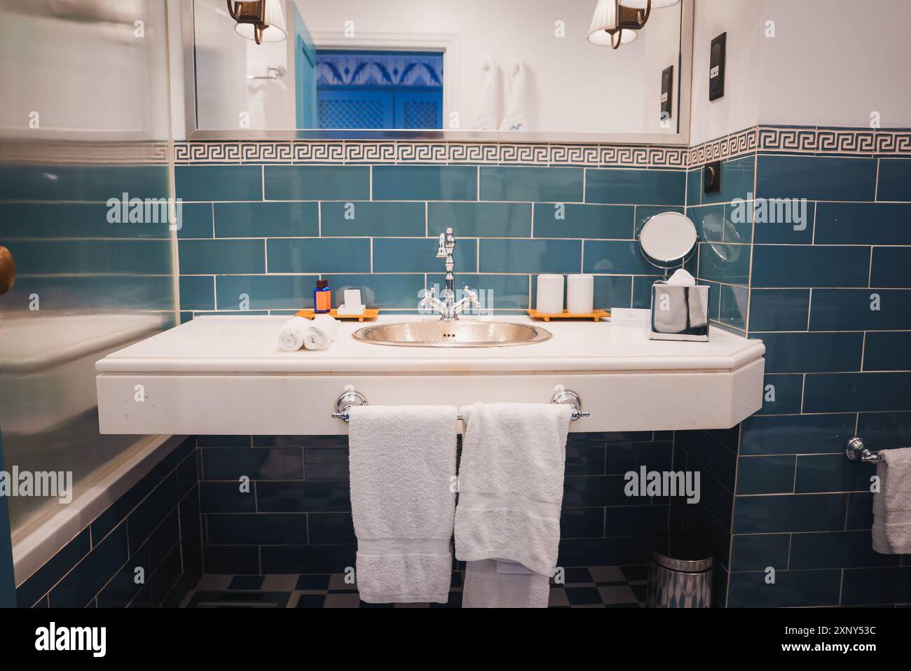 Luxurious Bathroom with Teal Greek Key Tiles and Polished Silver Faucet ...