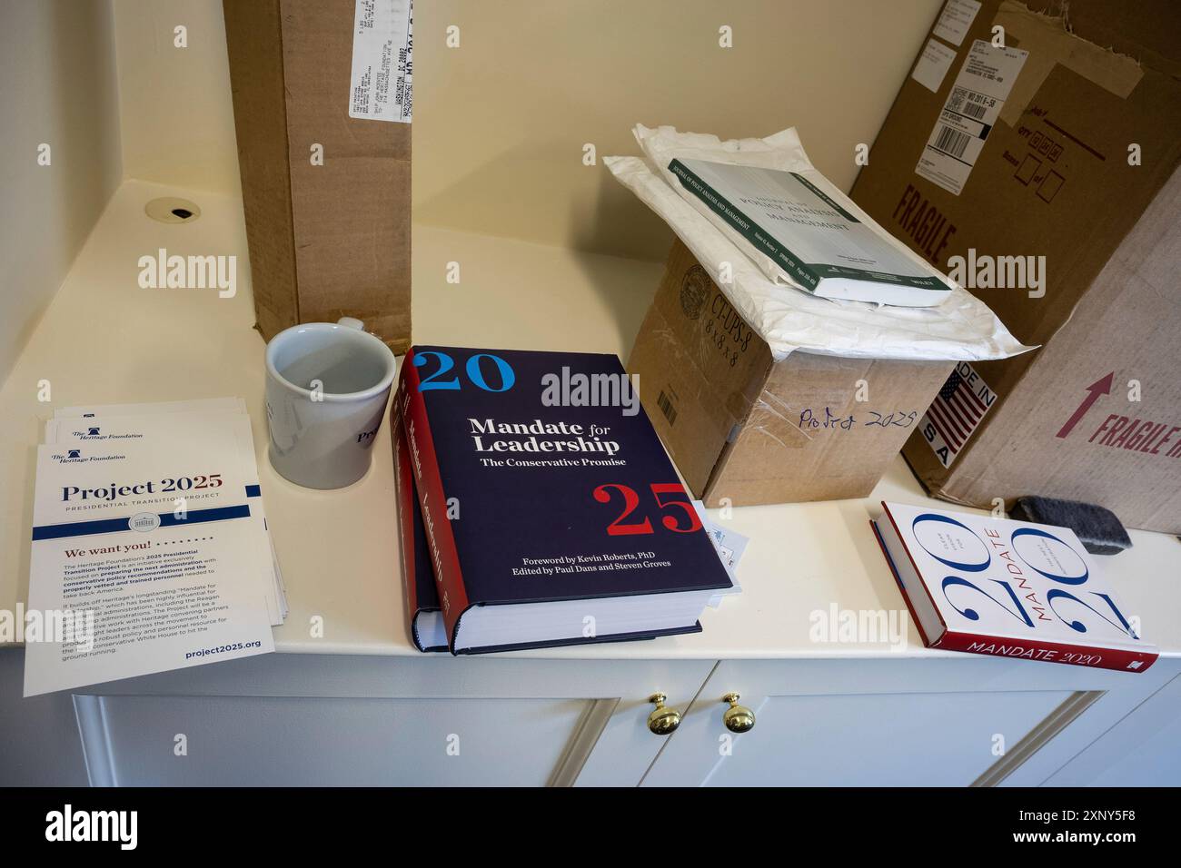 Project 2025 flyers, a Project 2025 mug, copies of the Project 2025 ...