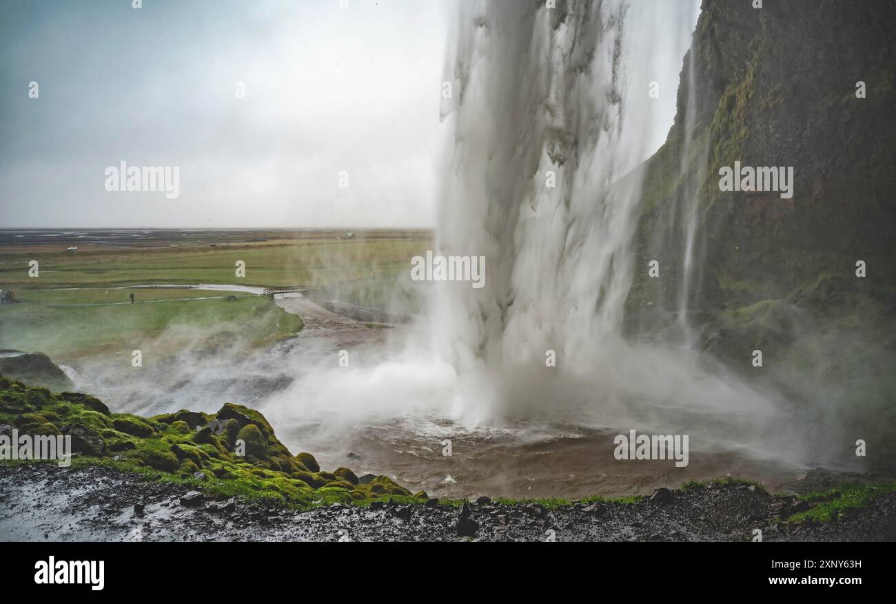 Underneath Seljalandsfoss Waterfall side view, Iceland Stock Photo - Alamy