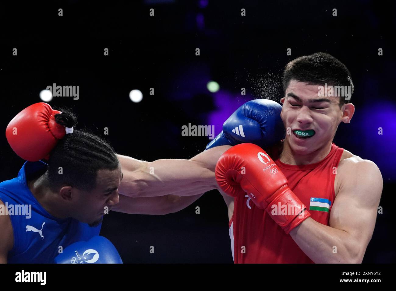 Cuba's Arlen Lopez hits Uzbekistan's Turabek Khabibullaev in their men ...