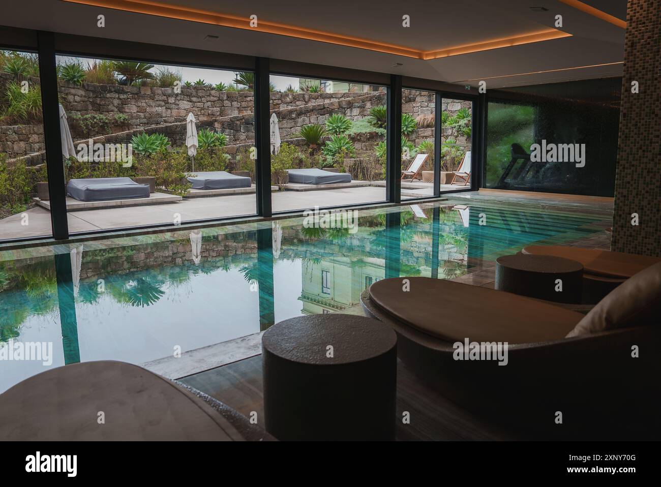 Elegant indoor swimming pool area in a luxury hotel, featuring modern ...