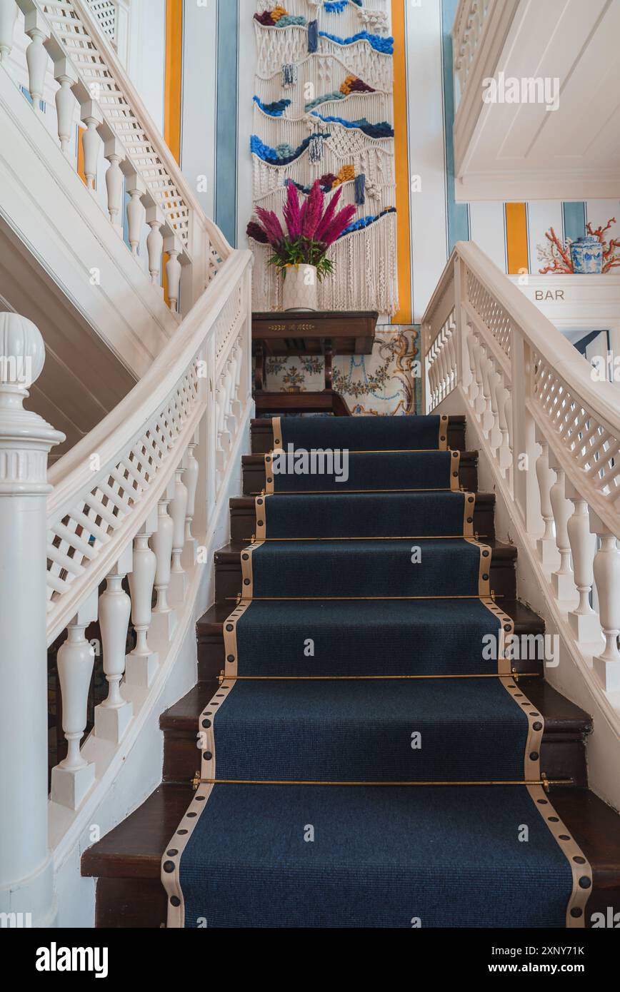 Elegant Staircase with Dark Blue Carpet and Gold Accents in Luxury ...