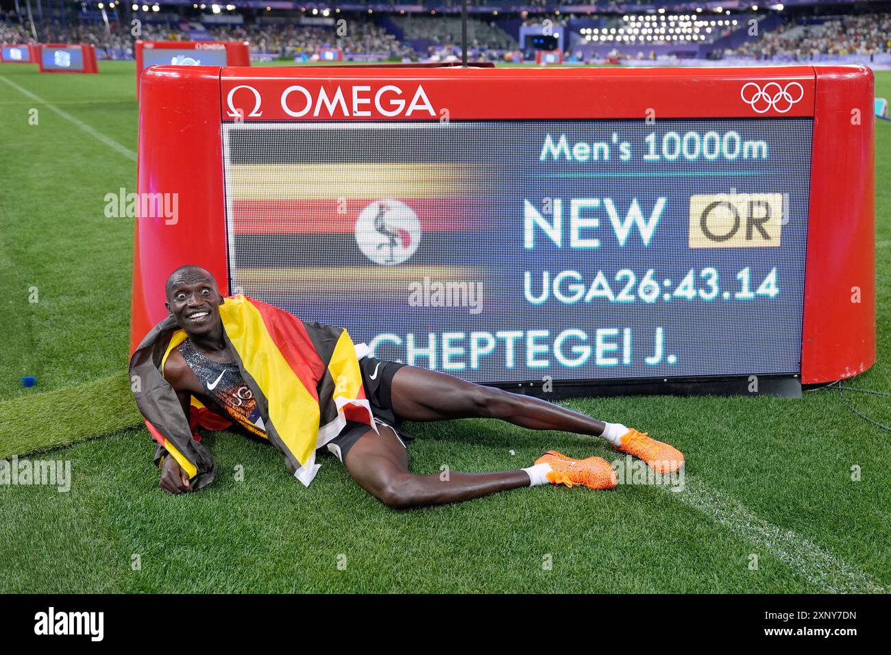 Joshua Cheptegei, of Uganda, poses for photos after winning the gold ...