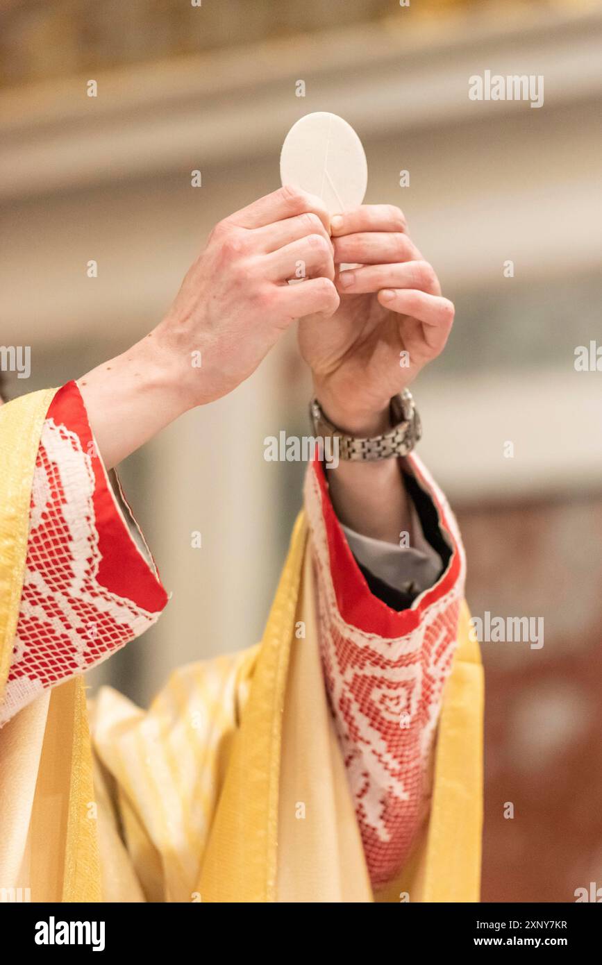 The elevation of the Sacramental Bread during the catholic liturgy ...