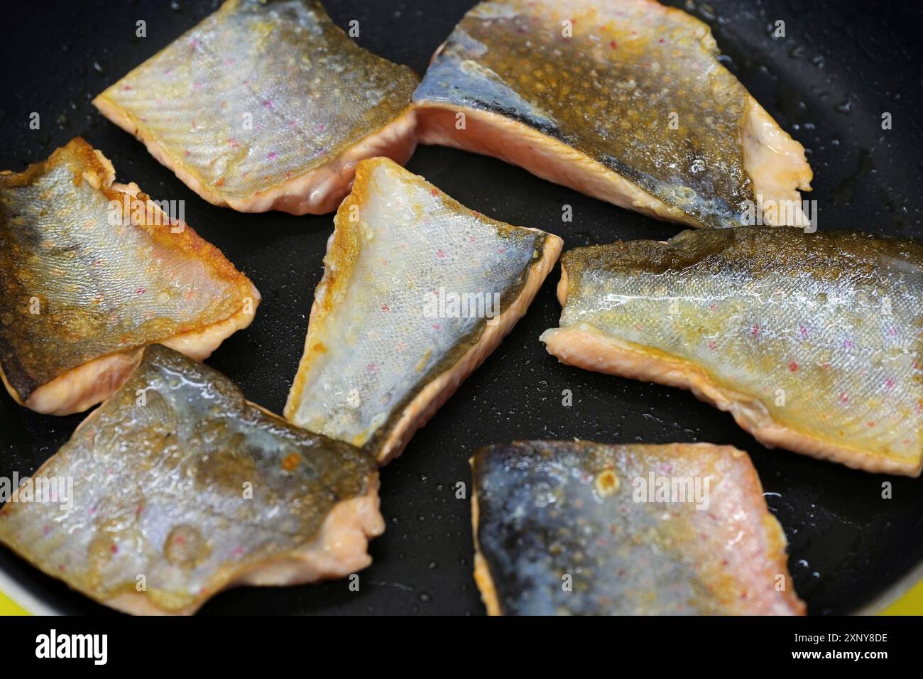 Char fish fillets fried on the skin and just turned over in a black pan ...