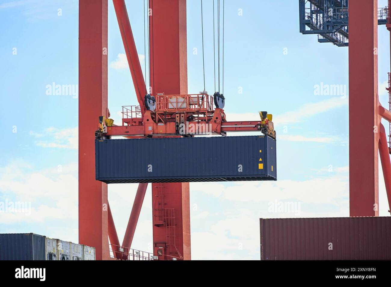 Terminal crane is moving a container in the industrial cargo por ...